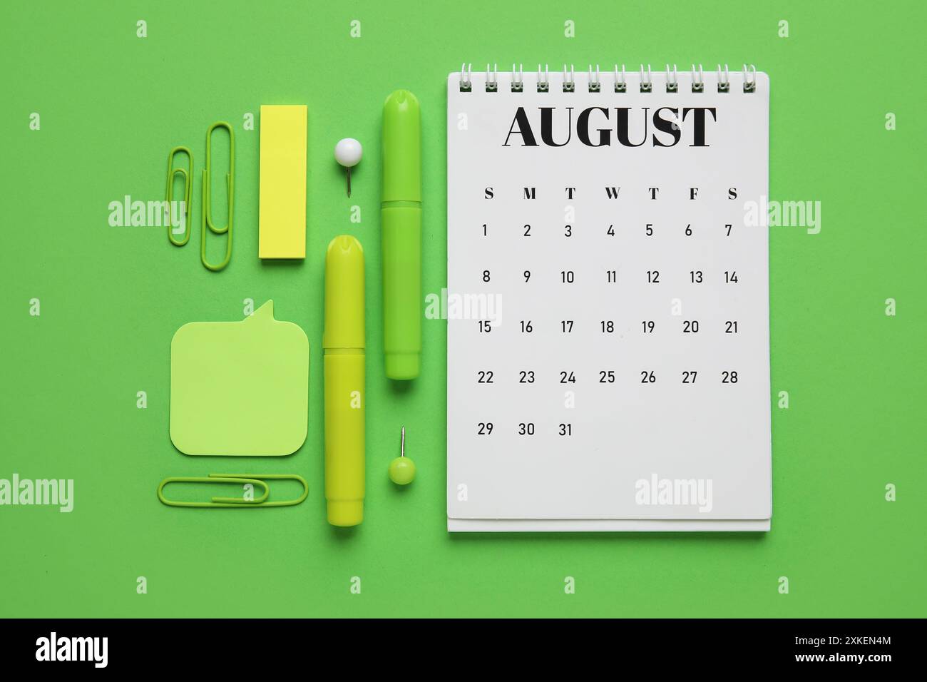 Calendar with office stationery on green background Stock Photo - Alamy