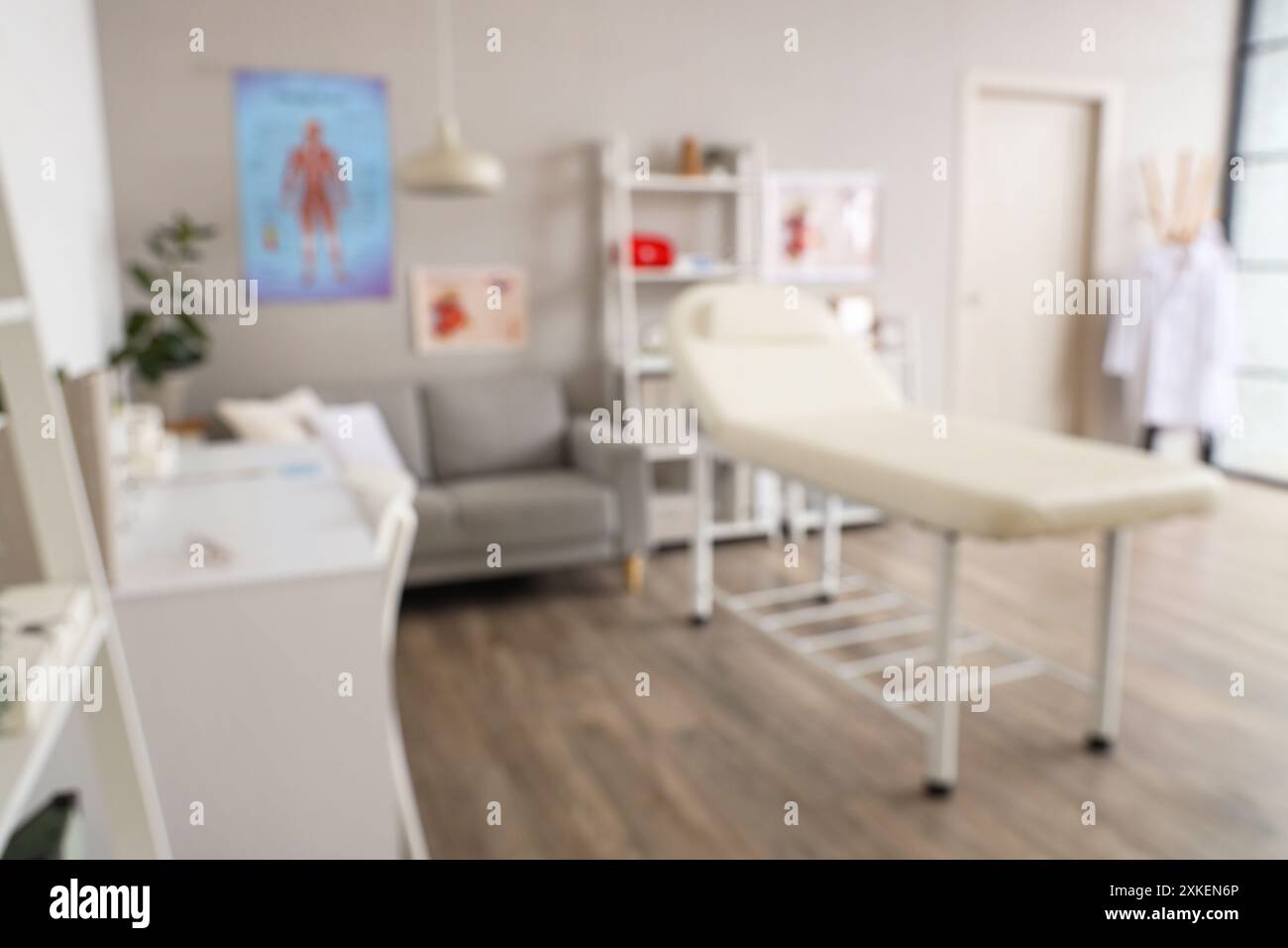 Blurred view of medical office with couch, doctor's workplace and sofa ...