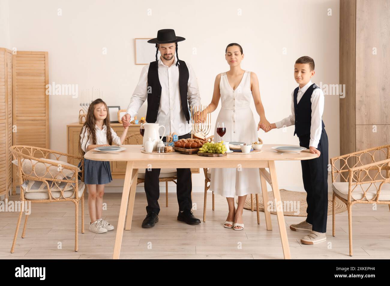 Happy Jewish family praying before dinner at home Stock Photo - Alamy