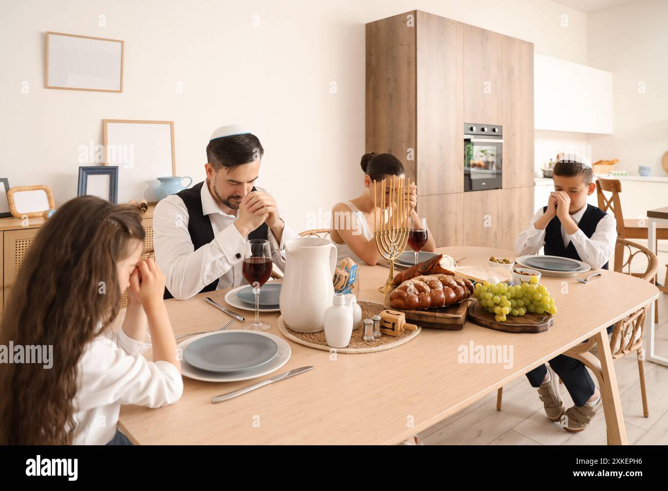 Jewish family praying before dinner at home Stock Photo - Alamy