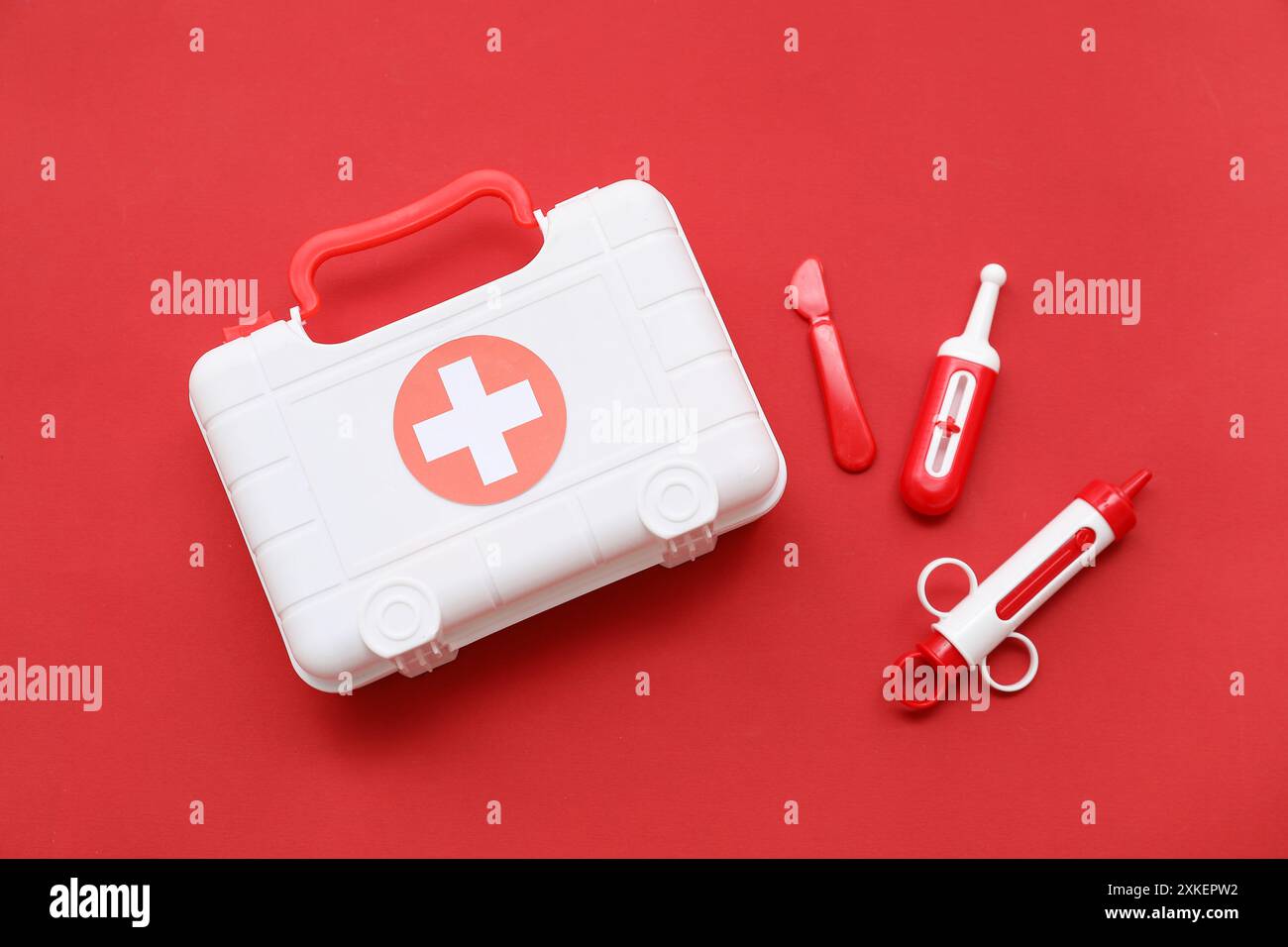 Toy first aid kit on red background Stock Photo - Alamy