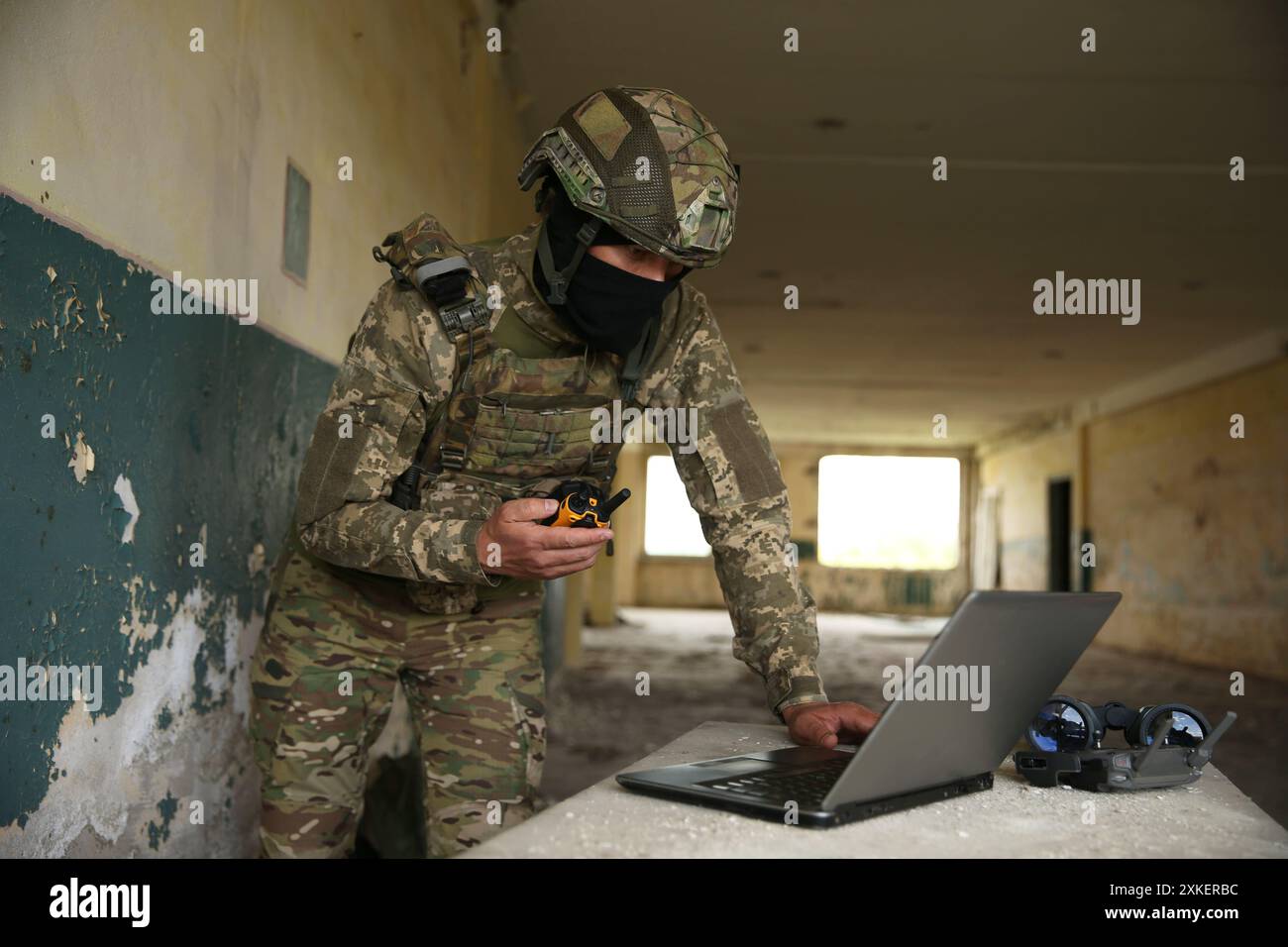 Military mission. Soldier in uniform with radio transmitter using ...