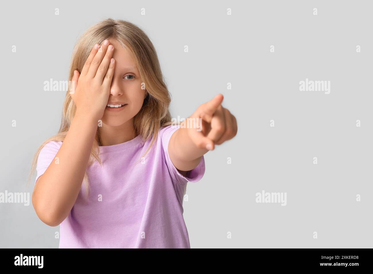 Teenage girl checking her eyesight on light background. Children's Eye ...