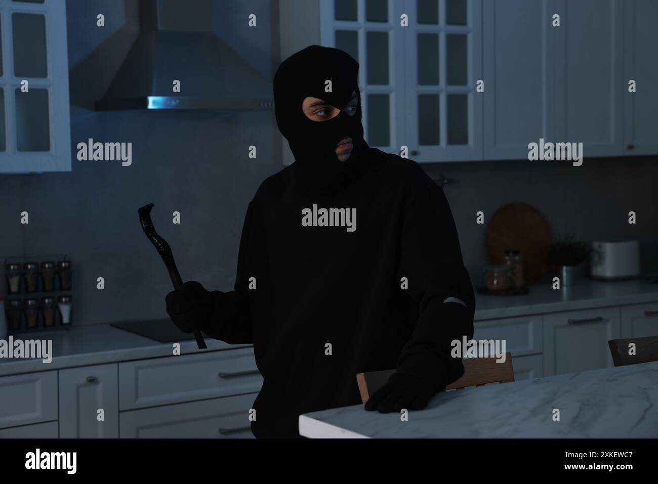 Thief wearing balaclava with crowbar in foreign house. Burglary Stock ...