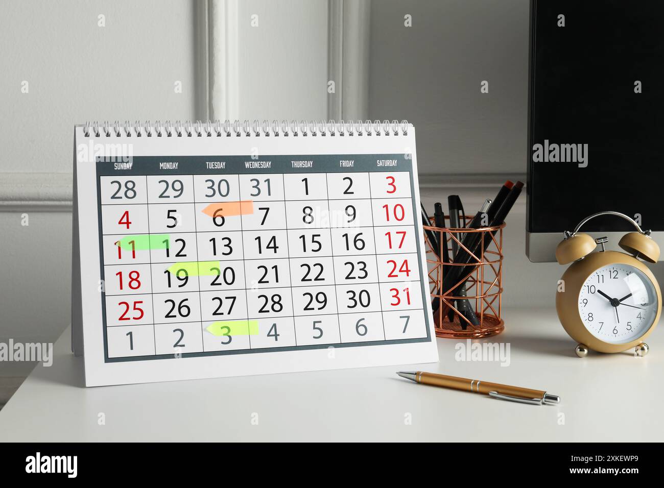 Timetable. Calendar with marked dates, alarm clock and stationery on ...