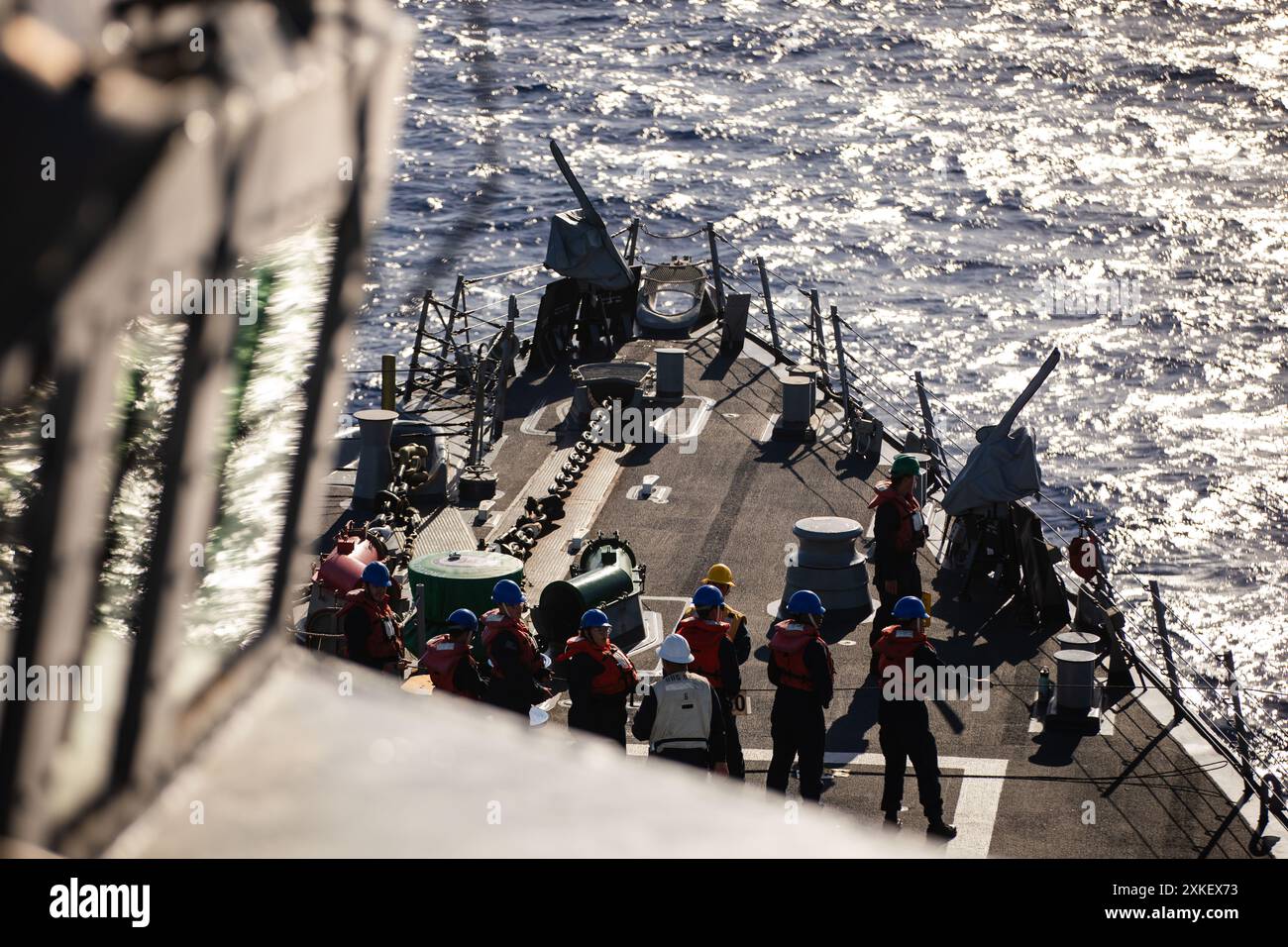 Sailors handle line aboard the Arleigh Burke-class guided missile ...
