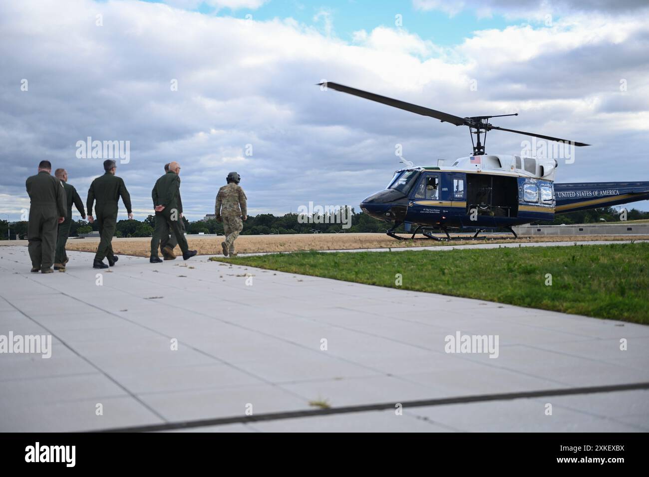 French air and space force officials approach a UH-1N Huey helicopter ...