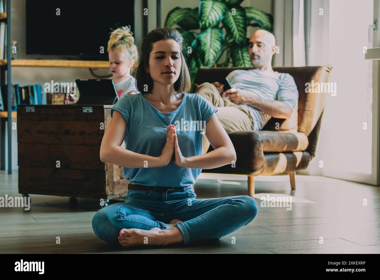 Young mother is maintaining her inner balance by practicing yoga and ...