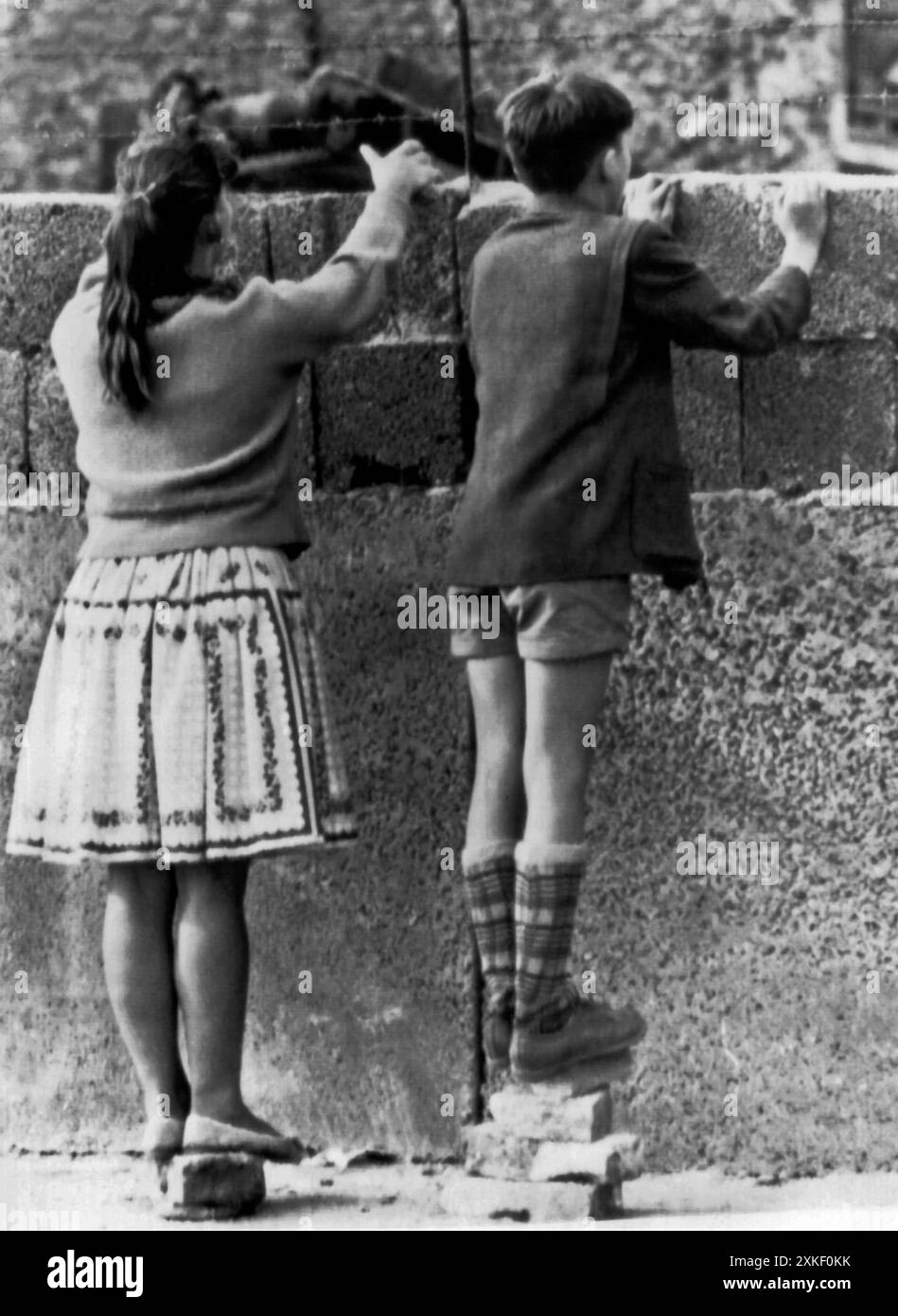 Berlin, West Germany August 29, 1961 Two West German children peer over ...