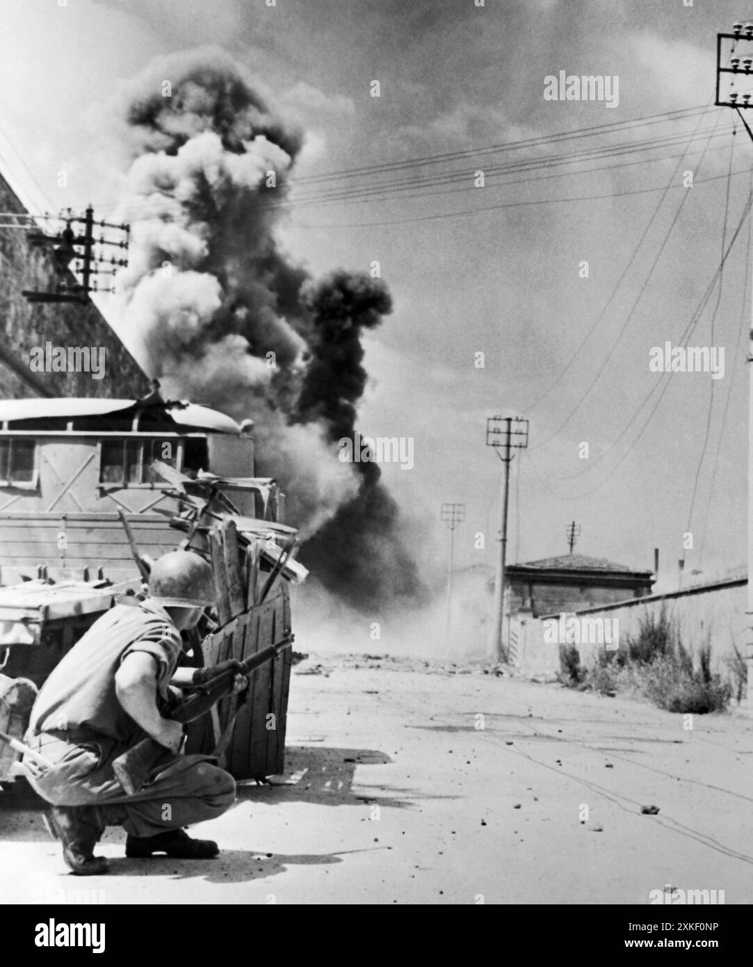 Leghorn, Italy August 7, 1944 Taking cover behind a tank, CPL Duane T ...