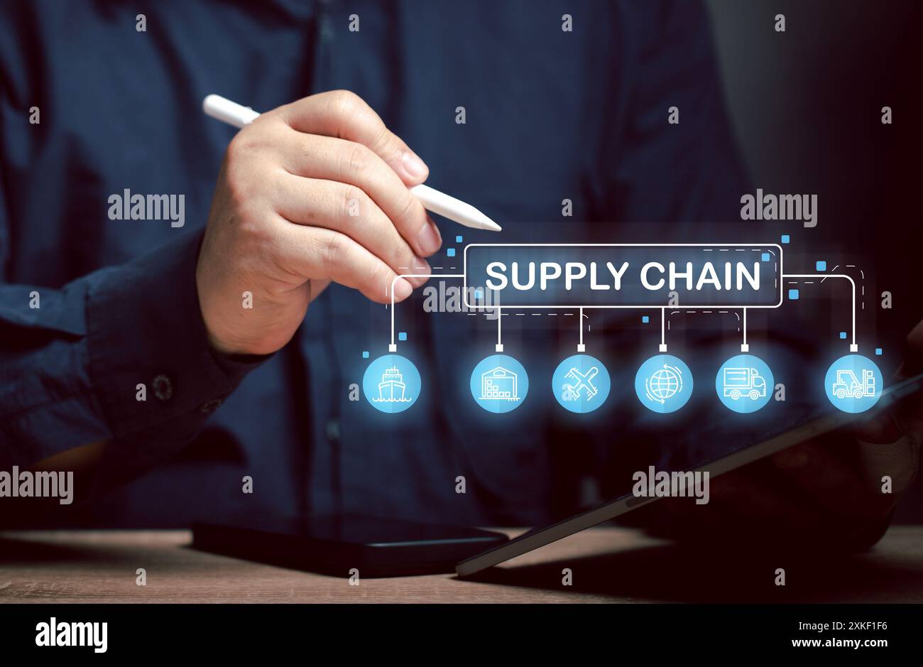 man uses pointer pen on supply chain chart to make decisions at virtual ...