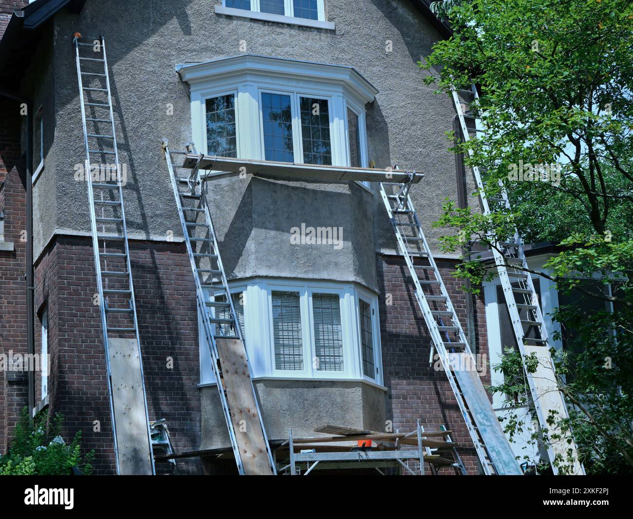 House being repaired with ladders leaning against it Stock Photo - Alamy