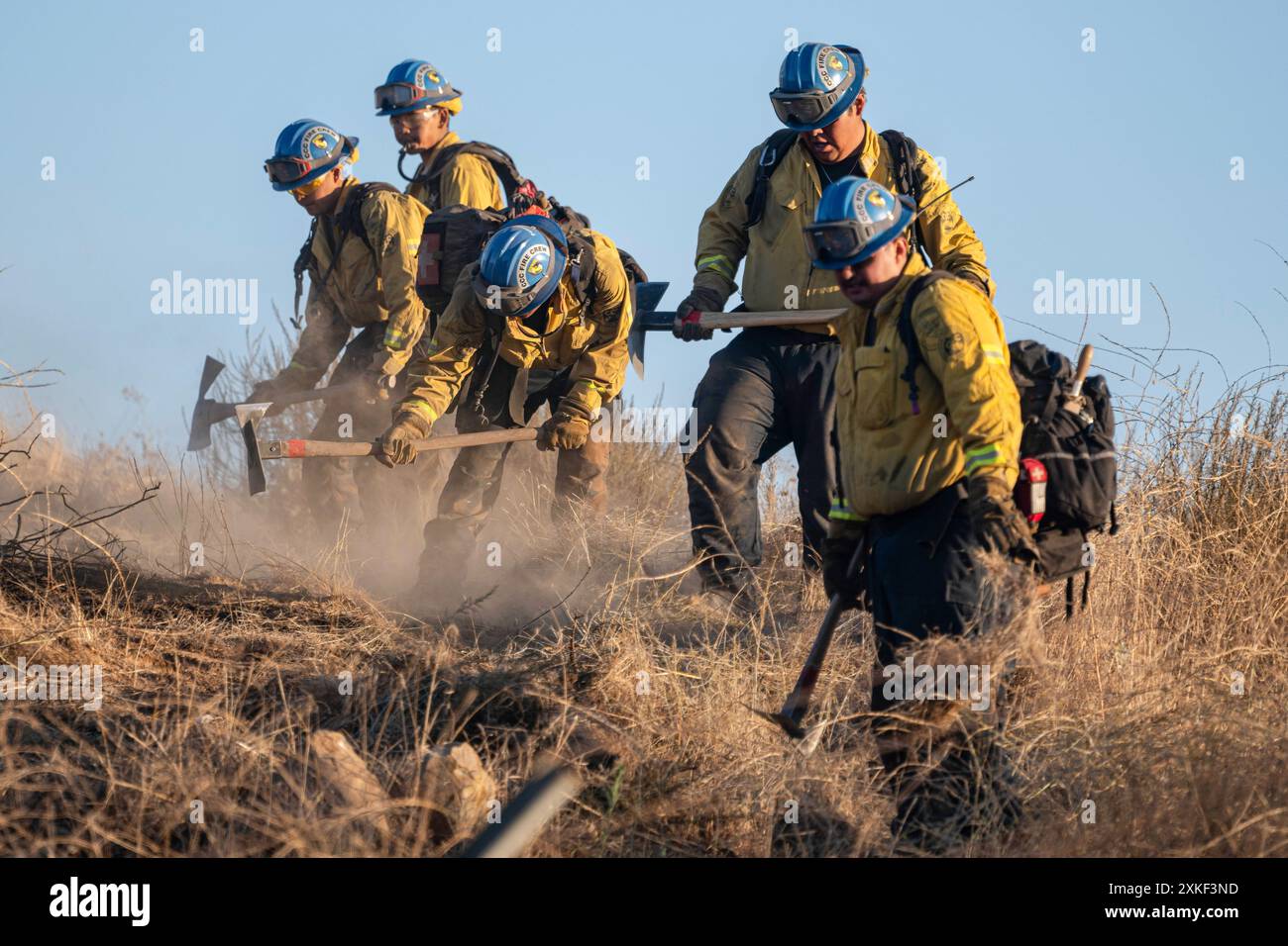Cal Fire Firefighters seen cutting a line as the Hawarden fire makes ...