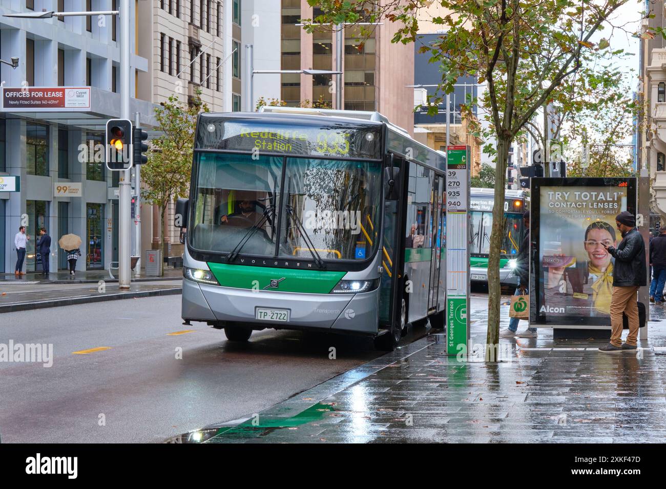 A Transperth bus at a bus stop on St Georges Terrace on a rainy day in ...