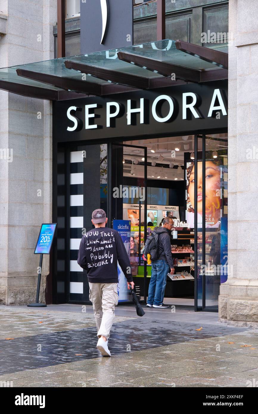 A man walking towards the entrance of the Sephora cosmetics store in ...