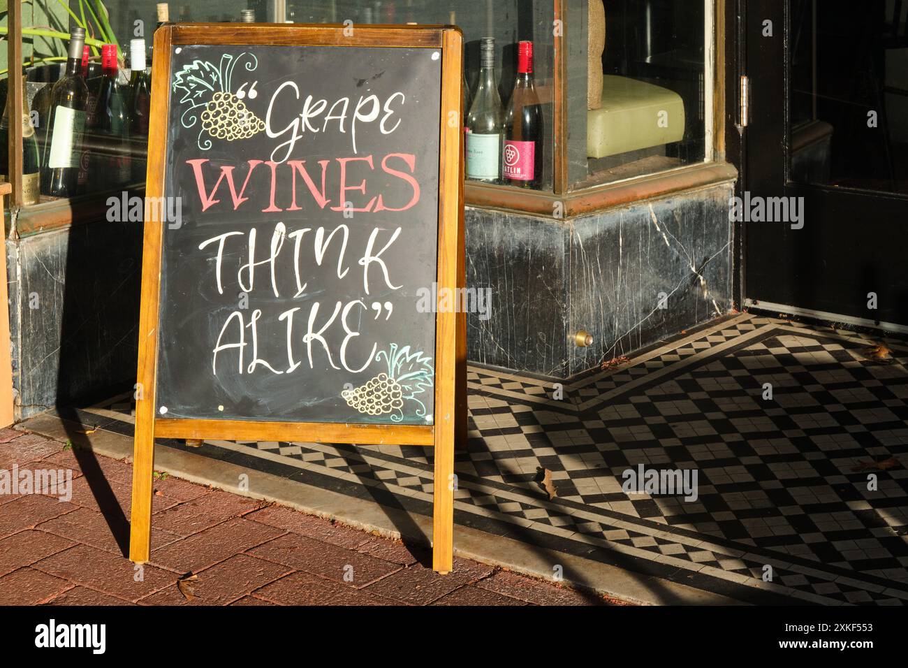 A sign outside Lums Wine Bar saying Grape Wines Think Alike with wine ...