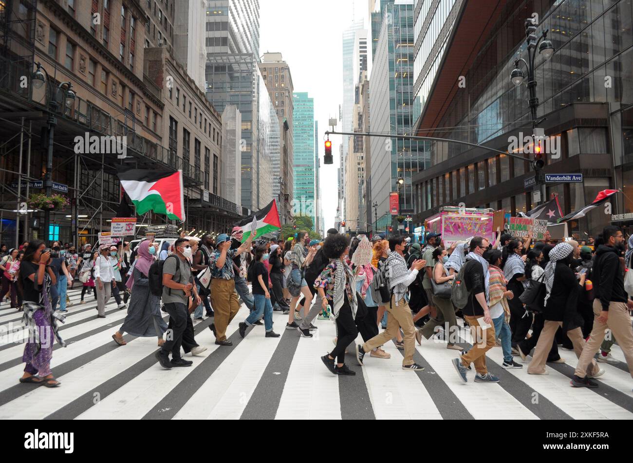 Pro-Palestine demonstrators march waving Palestinian flags. Pro ...