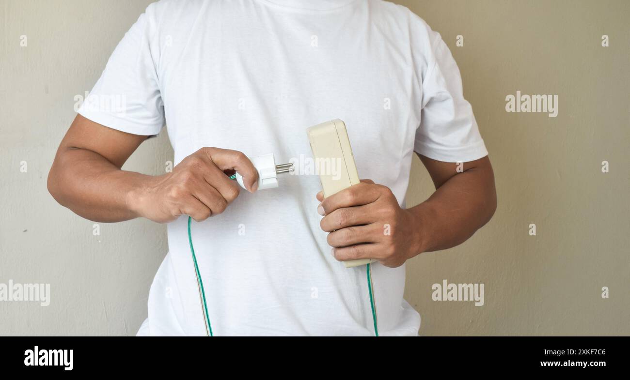 Business man connect two cables Stock Photo - Alamy