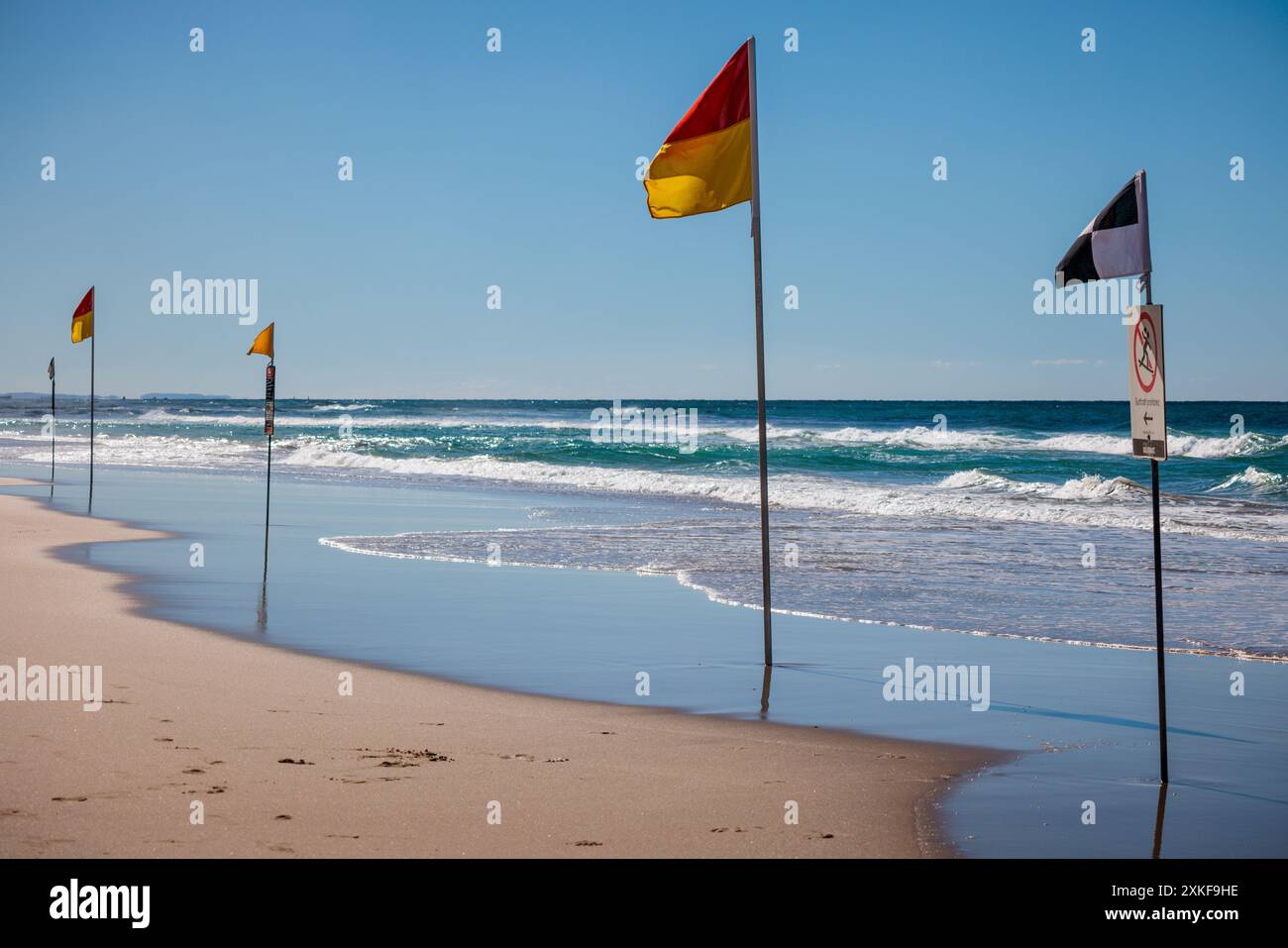 Beach safety flags for swimming and surfing on the shore at Broadbeach ...