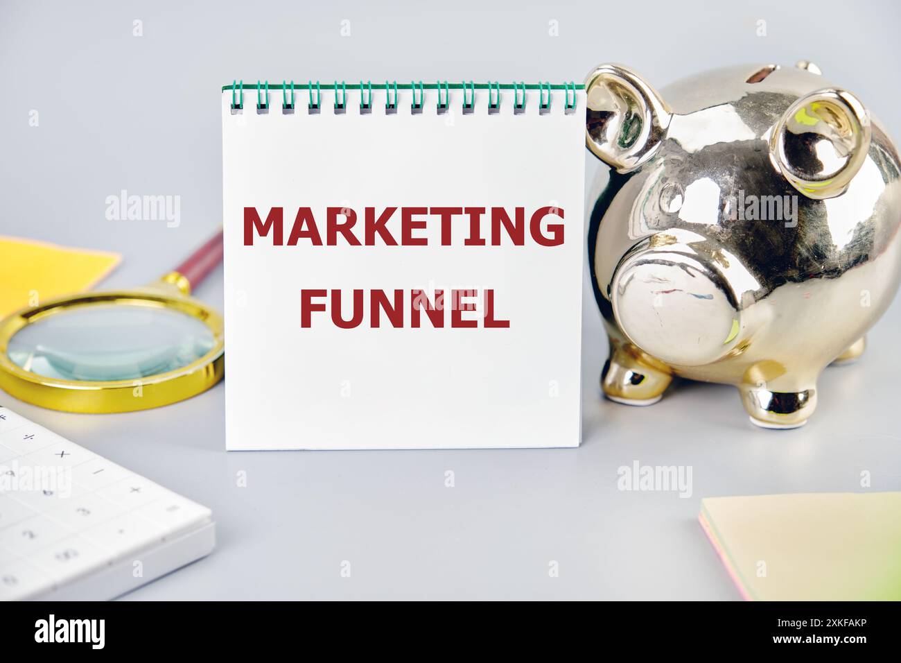 MARKETING FUNNEL written word on a notepad on a gray background next to ...