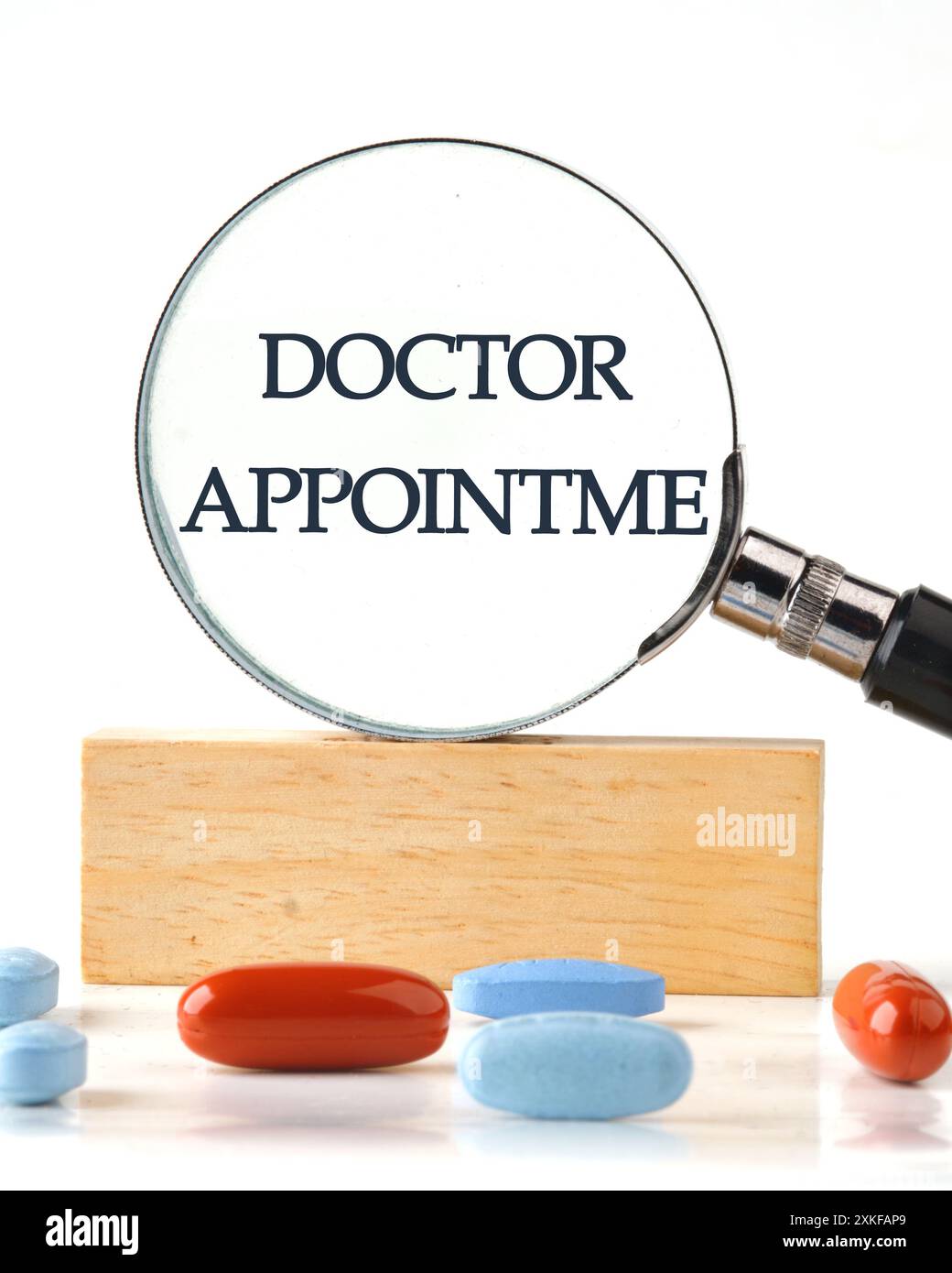 The words DOCTOR APPOINTMENT written through a magnifying glass on a ...