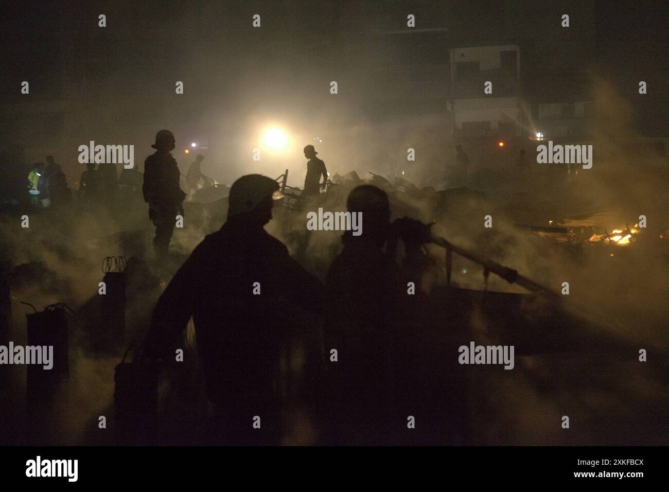 Firefighters performing the cooling phase after a fire accident burned ...