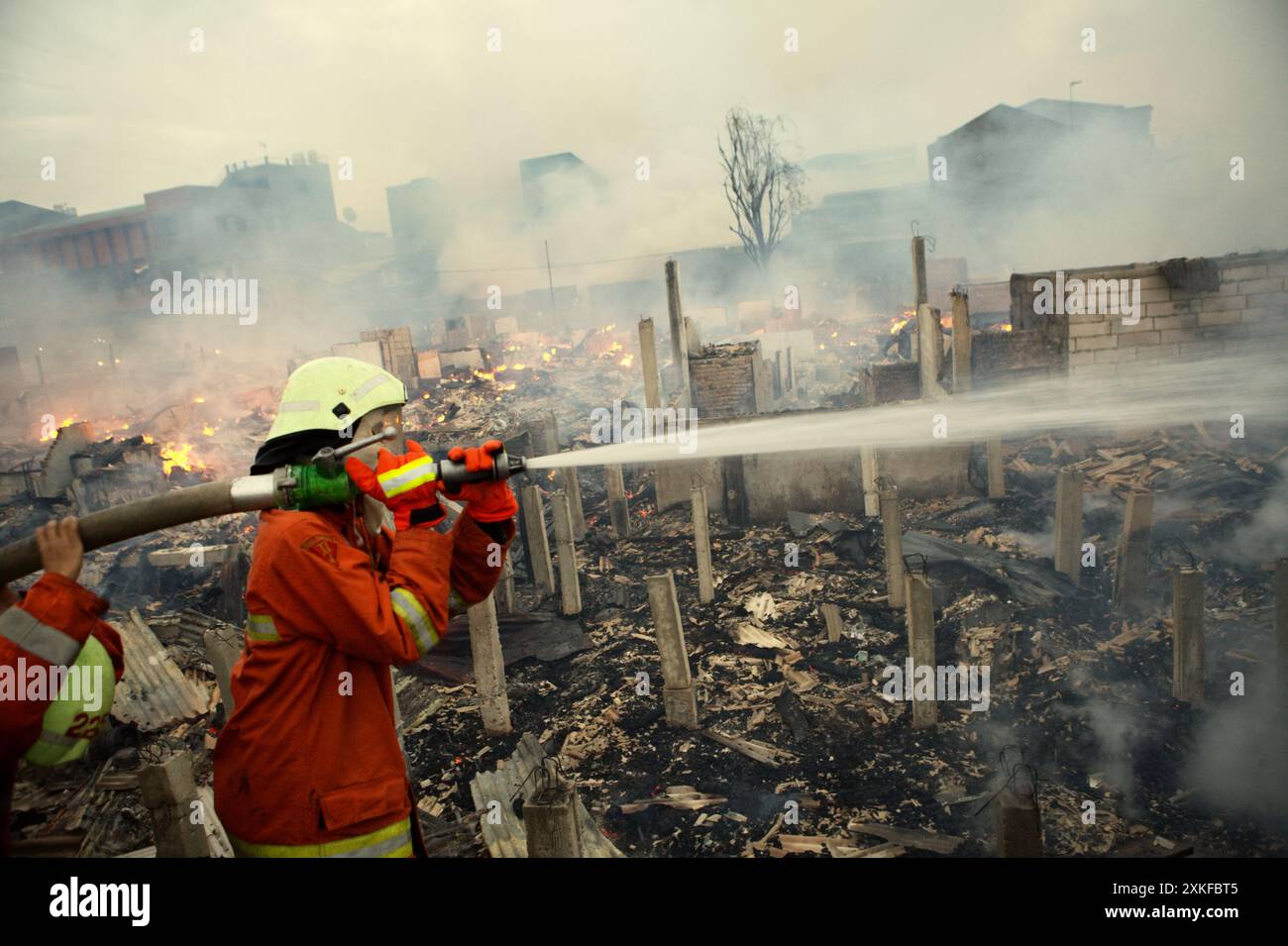 Firefighters performing the cooling phase after a fire accident burned ...
