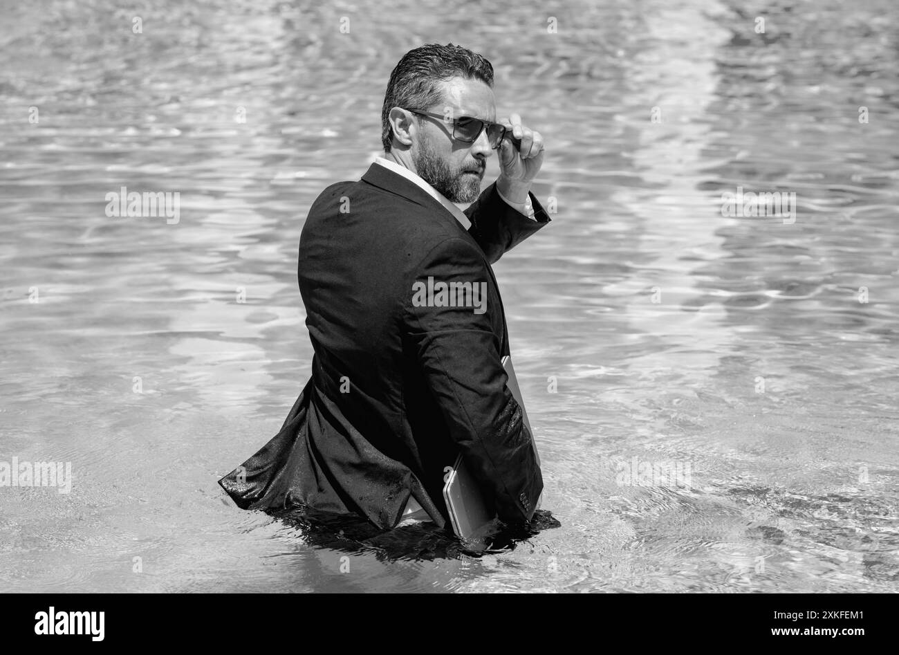 Using computer in swimming pool Black and White Stock Photos & Images ...