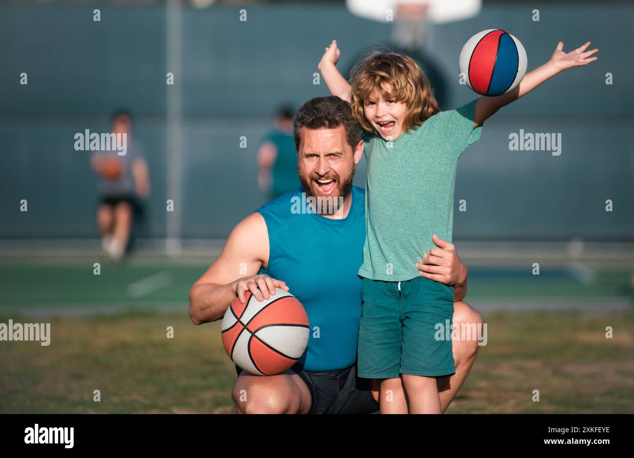 Cute boy with dad playing basketball. Dad and child spending time ...
