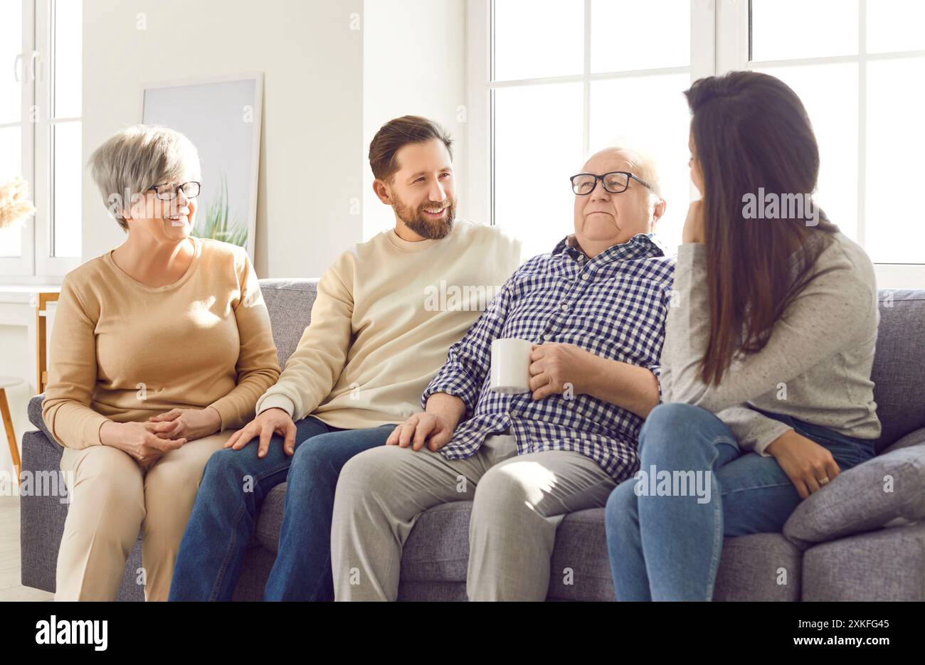 Family of senior old parents and their adult children sitting at home ...