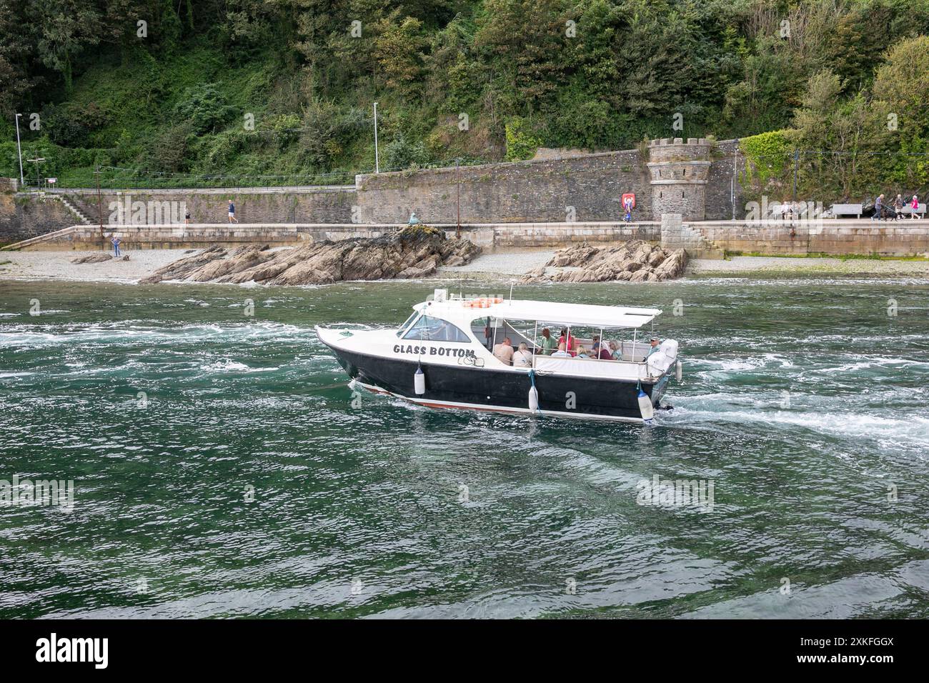 Looe Cornwall, glass bottom boat vessel on Looe harbour with tourists going for a boat tour ...