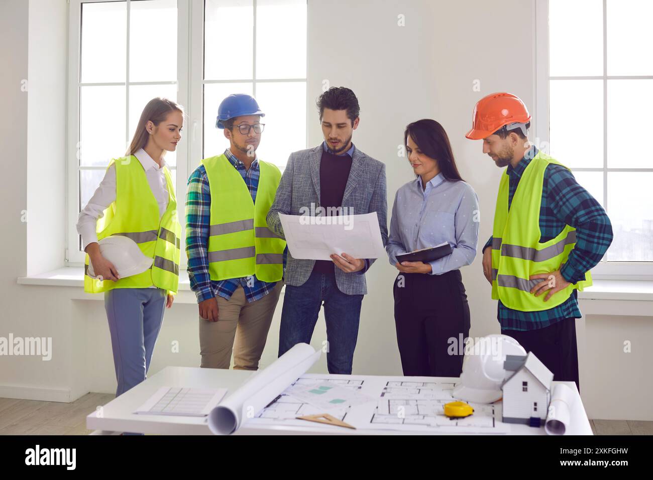 Team of architects and builders meeting in office and discussing ...