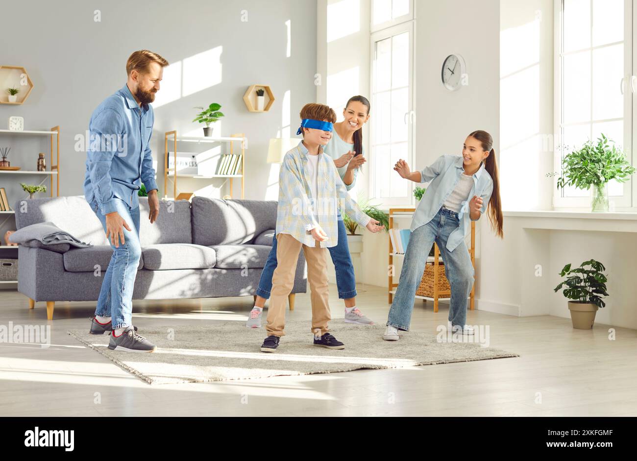 Large joyful family plays blindfolded games in living room. Children ...