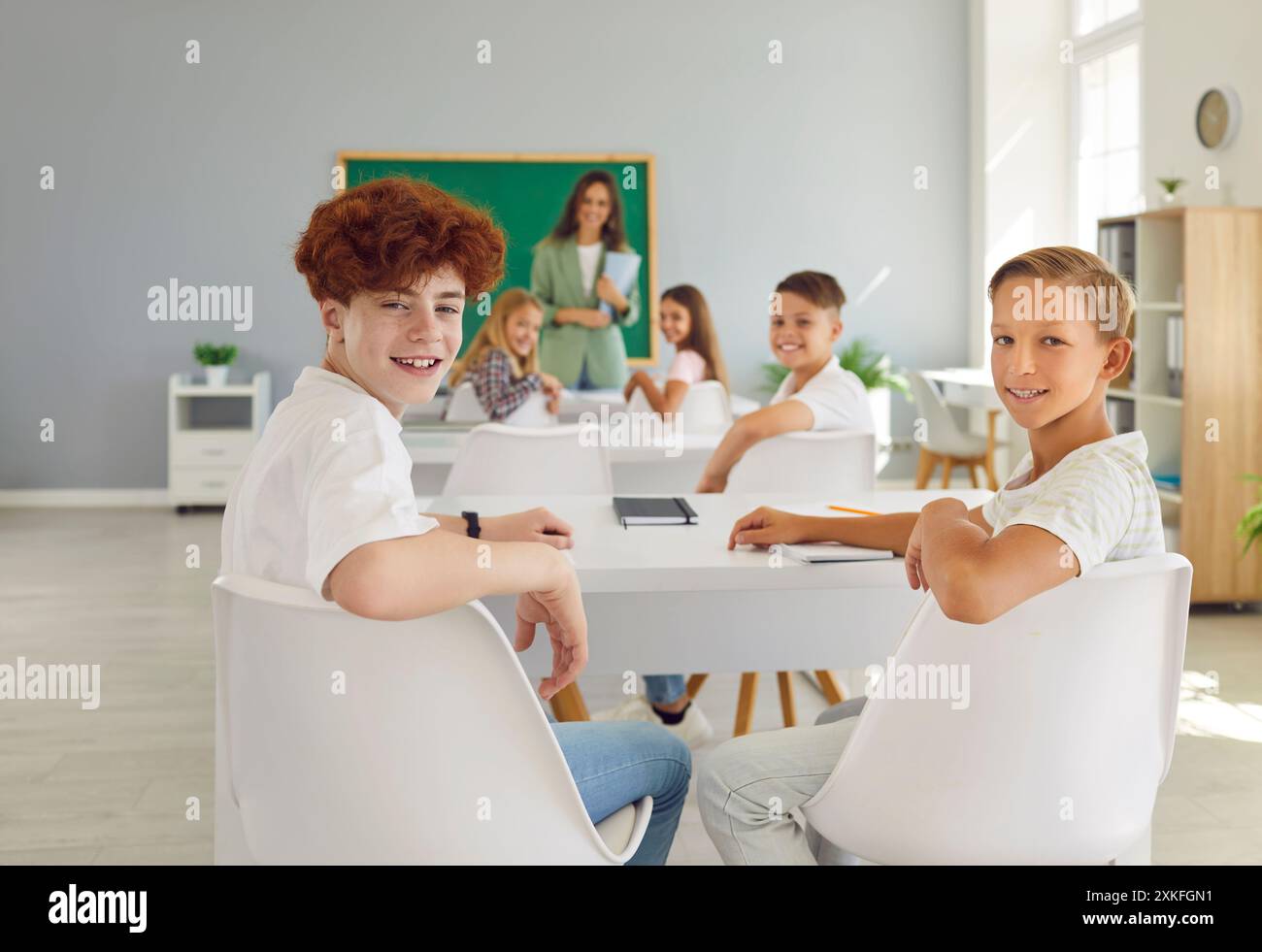 Portrait Of Two Happy Schoolboys In Classroom Stock Photo - Alamy