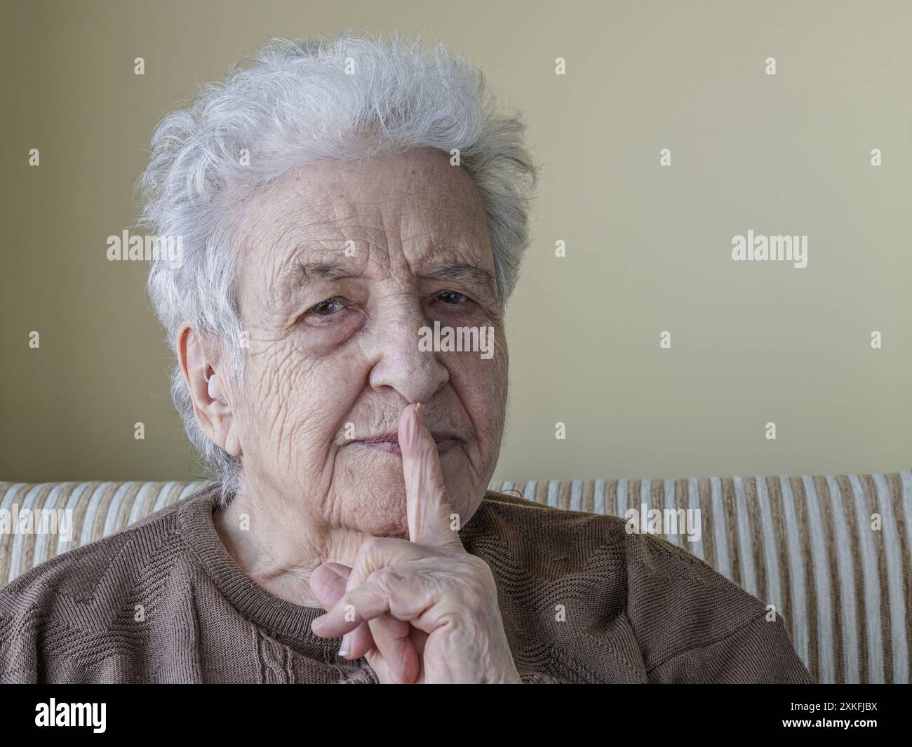 Pretty woman showing silence gesture hi-res stock photography and ...