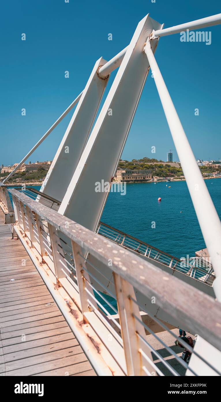 A modern bridge with steel structures stretches over peaceful blue ...