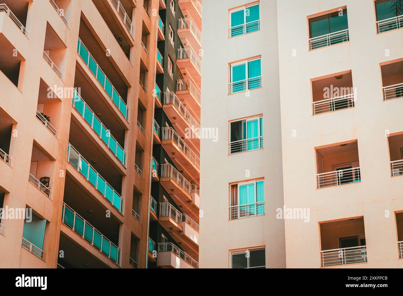 Two modern apartment buildings with multiple balconies and windows ...