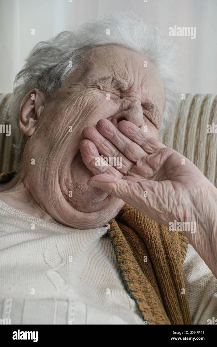 Portrait sleepy old woman yawning hi-res stock photography and images ...