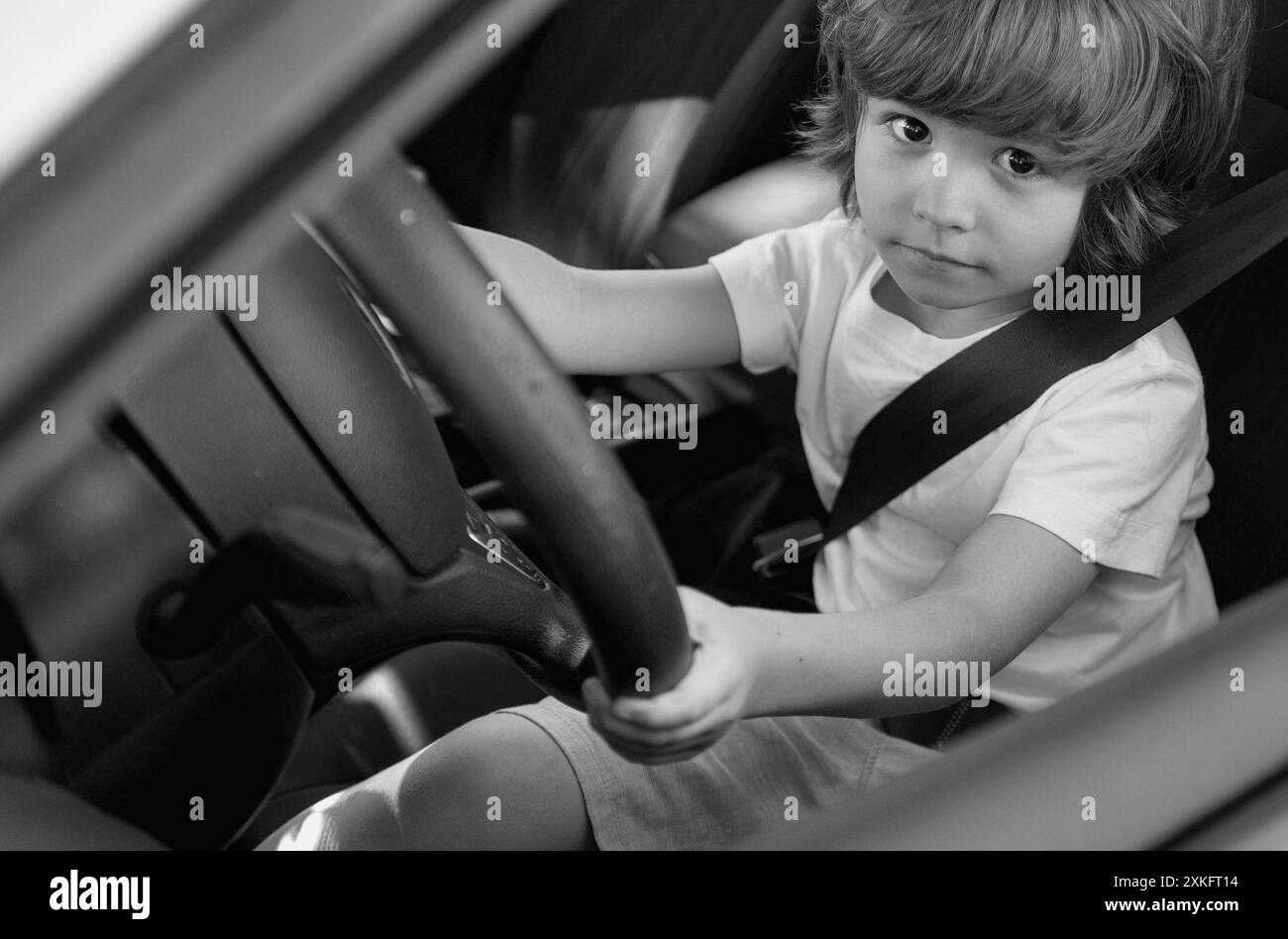 Little Driver. Cute little boy pretending to drive. Kid in car with his ...