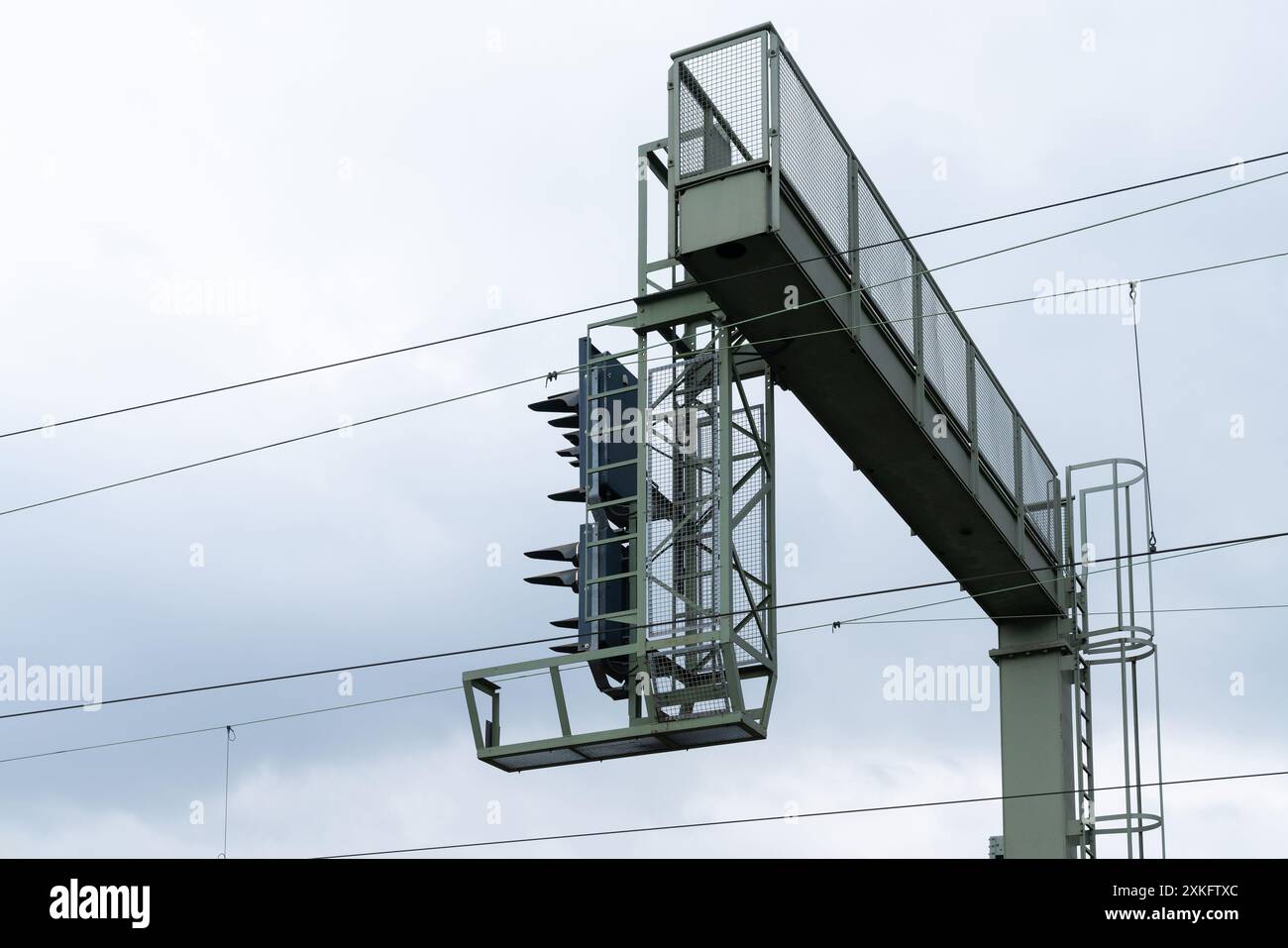 A metal railway signal tower with multiple lights and wires, set ...