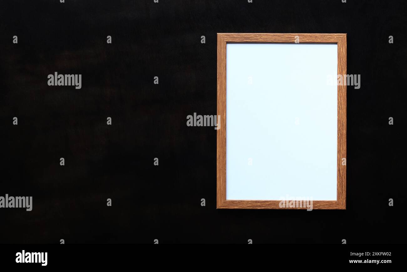 Blank frame for photo or text with white sheet on dark wooden ...