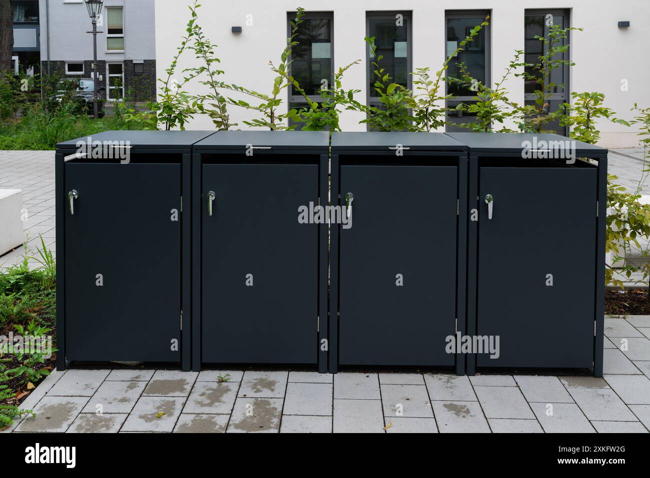 Black outdoor compact conceptual storage for 4 garbage cans, standing ...
