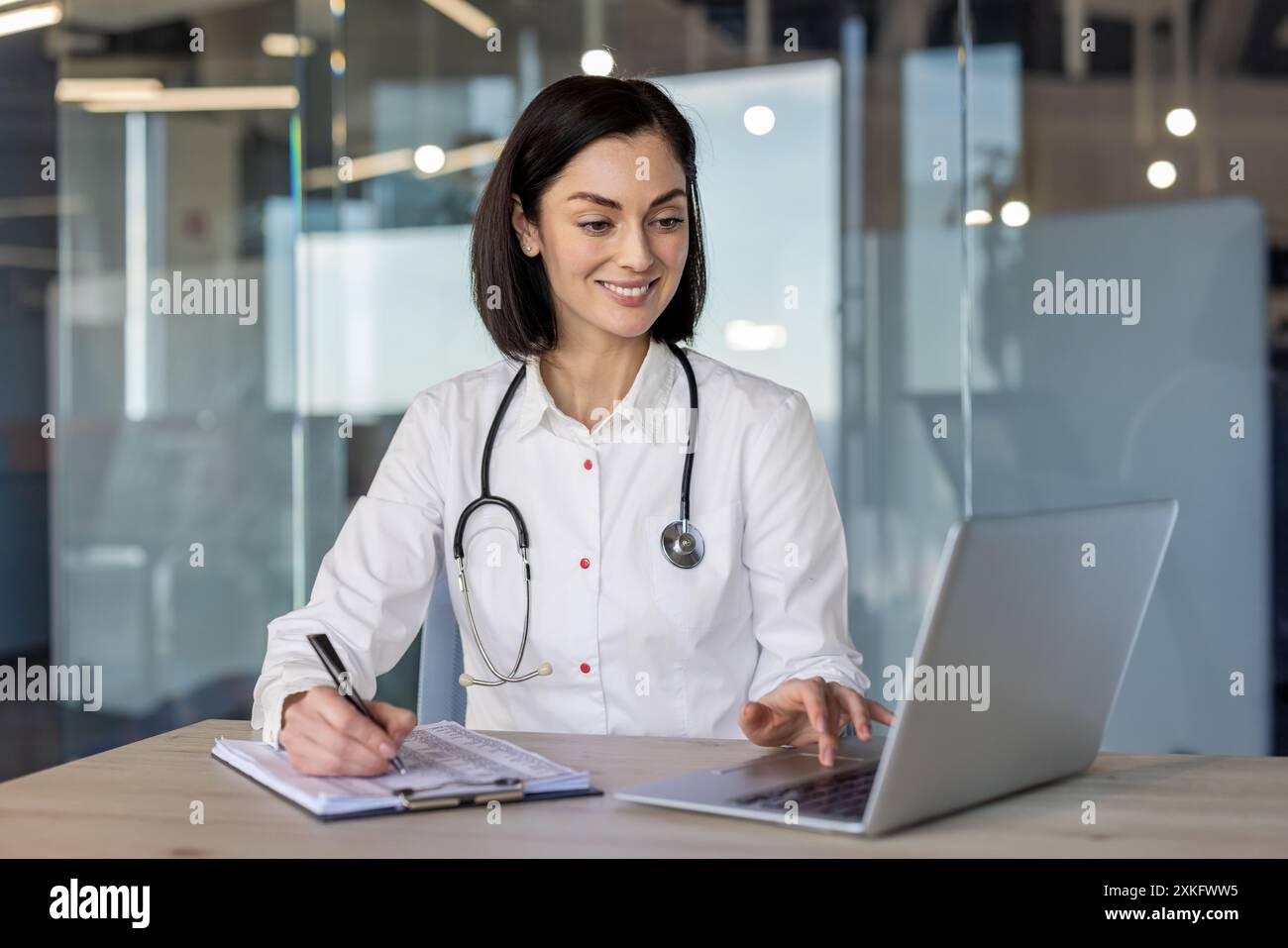 Medical worker taking notes treatment hi-res stock photography and ...