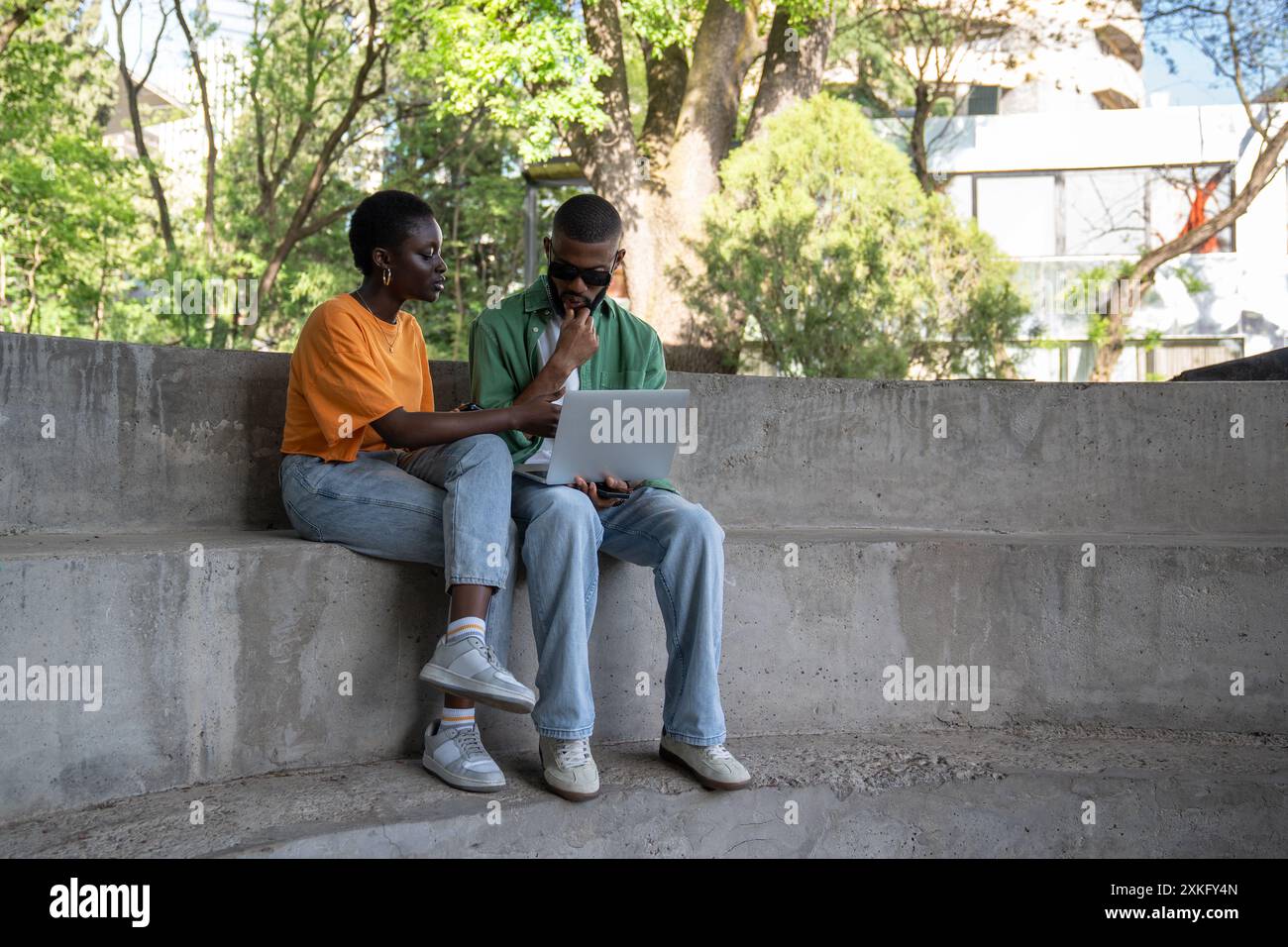 Thoughtful boyfriend, girlfriend classmates using computer to study ...
