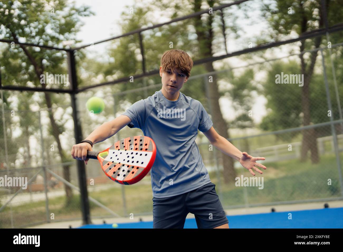 Young man playing padel tennis on outdoor court Stock Photo - Alamy