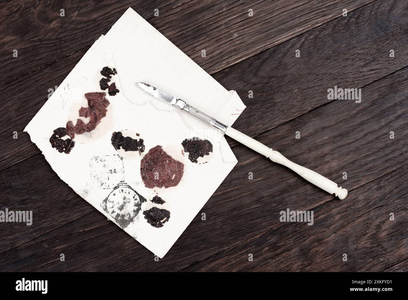 Retro envelope opener knife vintage letter envelope on wooden desk ...