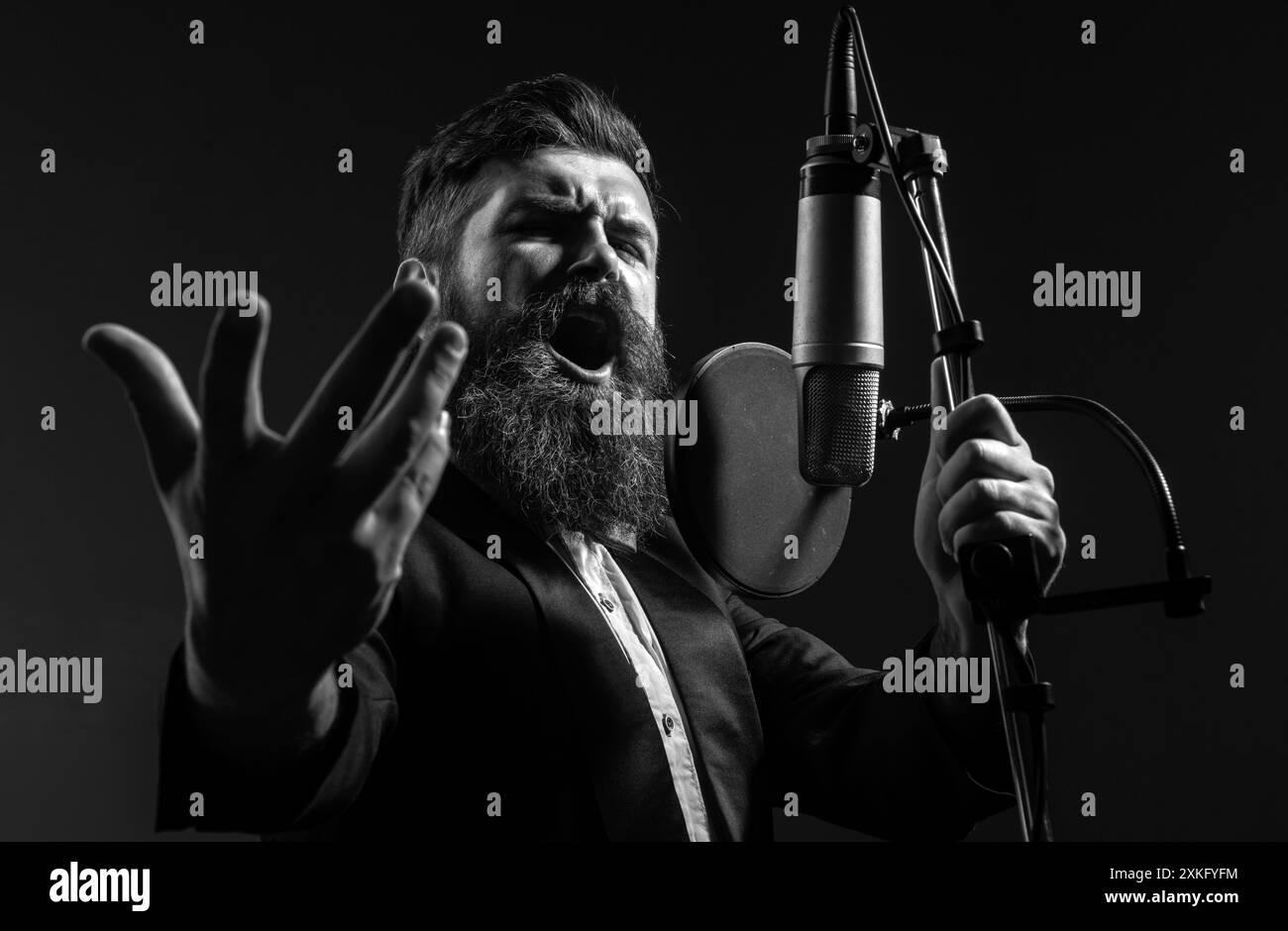 Classic singer in suit. Handsome man in recording studio. Music ...