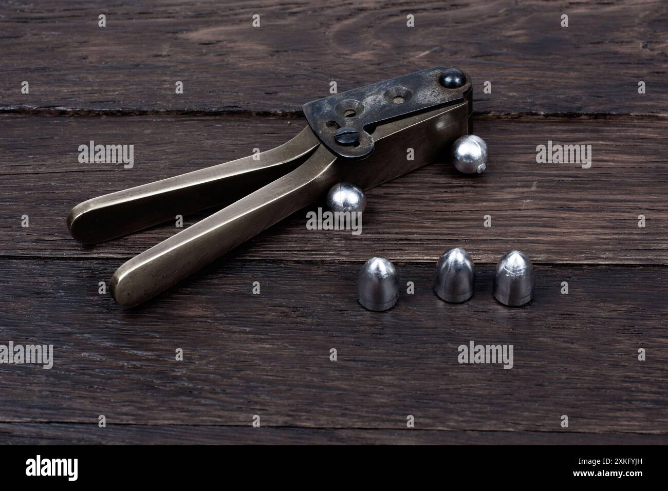 old west bullet mold with bullets for revolver. Isolated on white ...