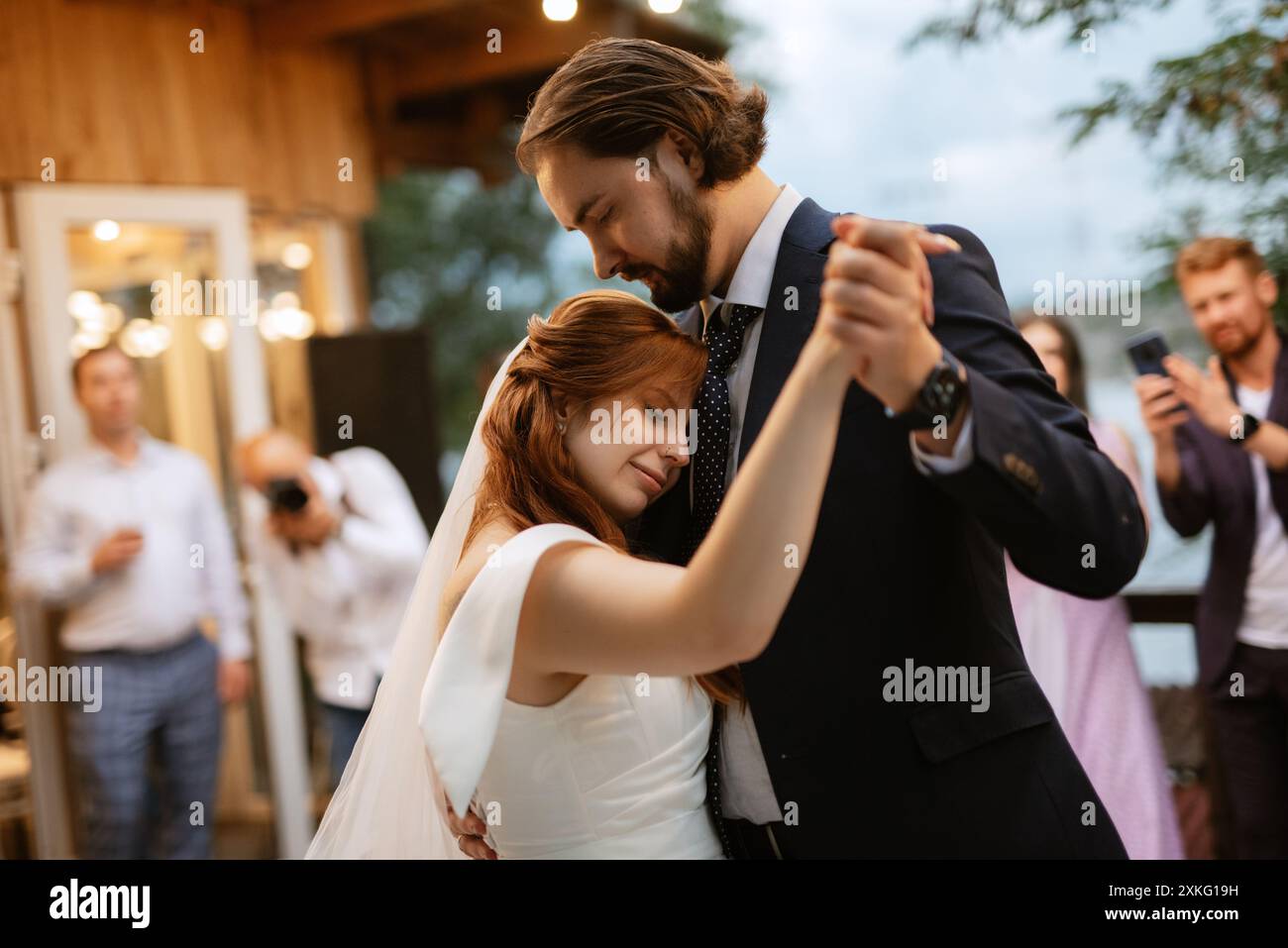 the first wedding dance of the bride and groom inside the restaurant ...