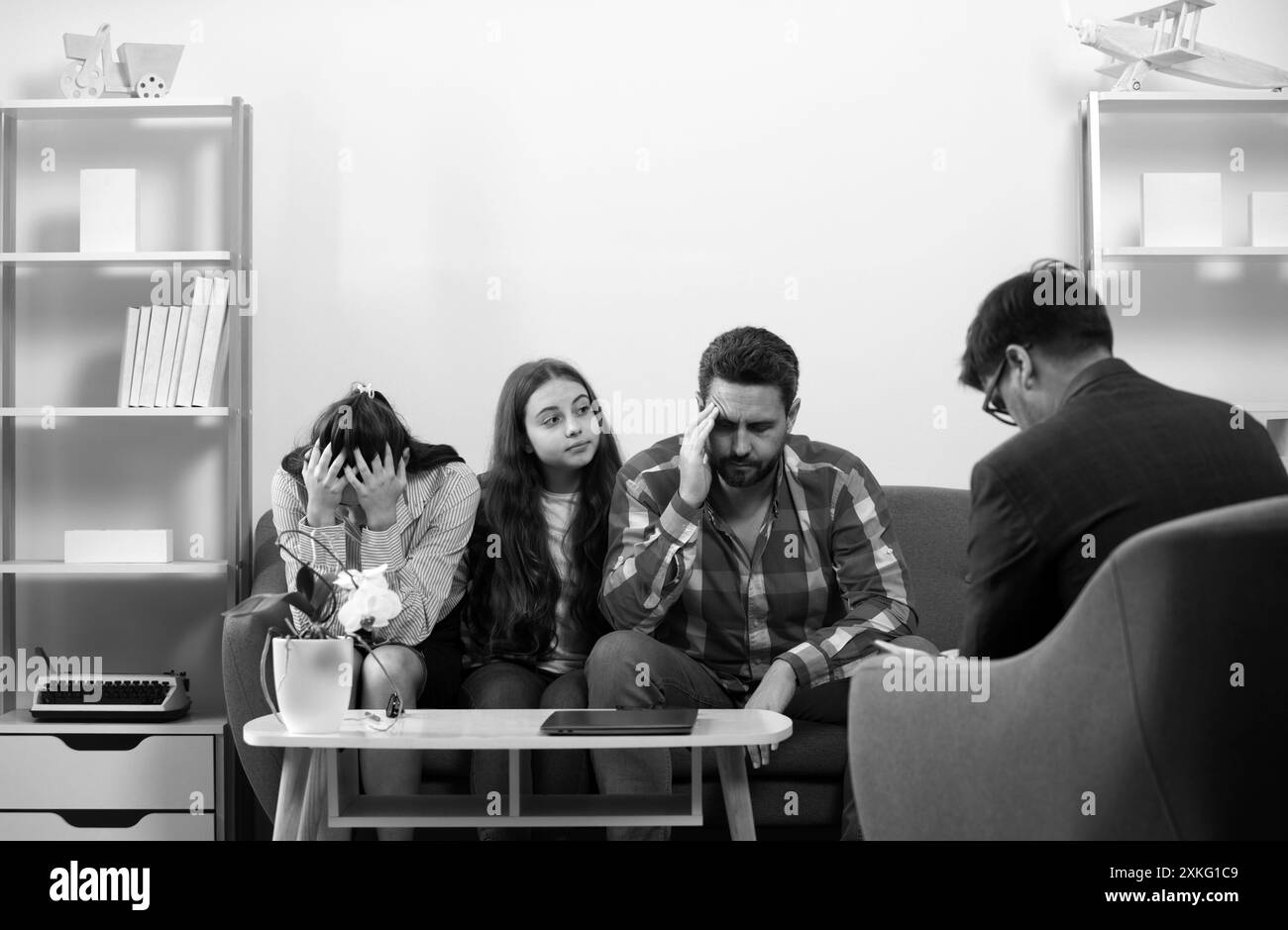 Psychologist helping young family with a child to solve teenagers ...